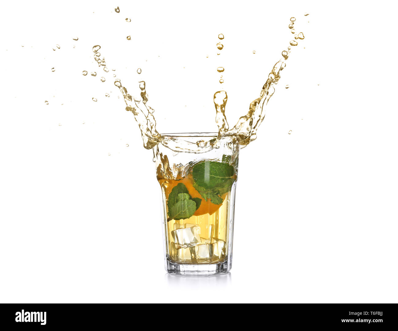Glass of splashing lemonade with citrus fruit on white background Stock ...