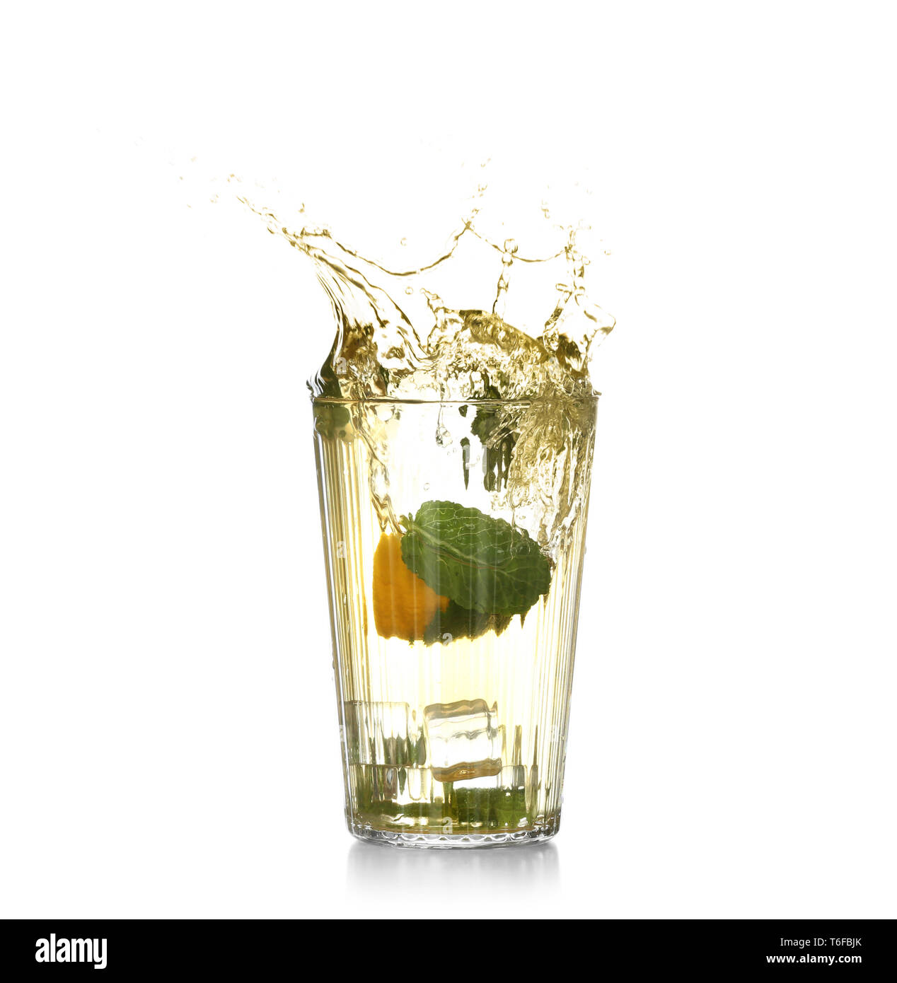 Glass of splashing lemonade with citrus fruit on white background Stock ...