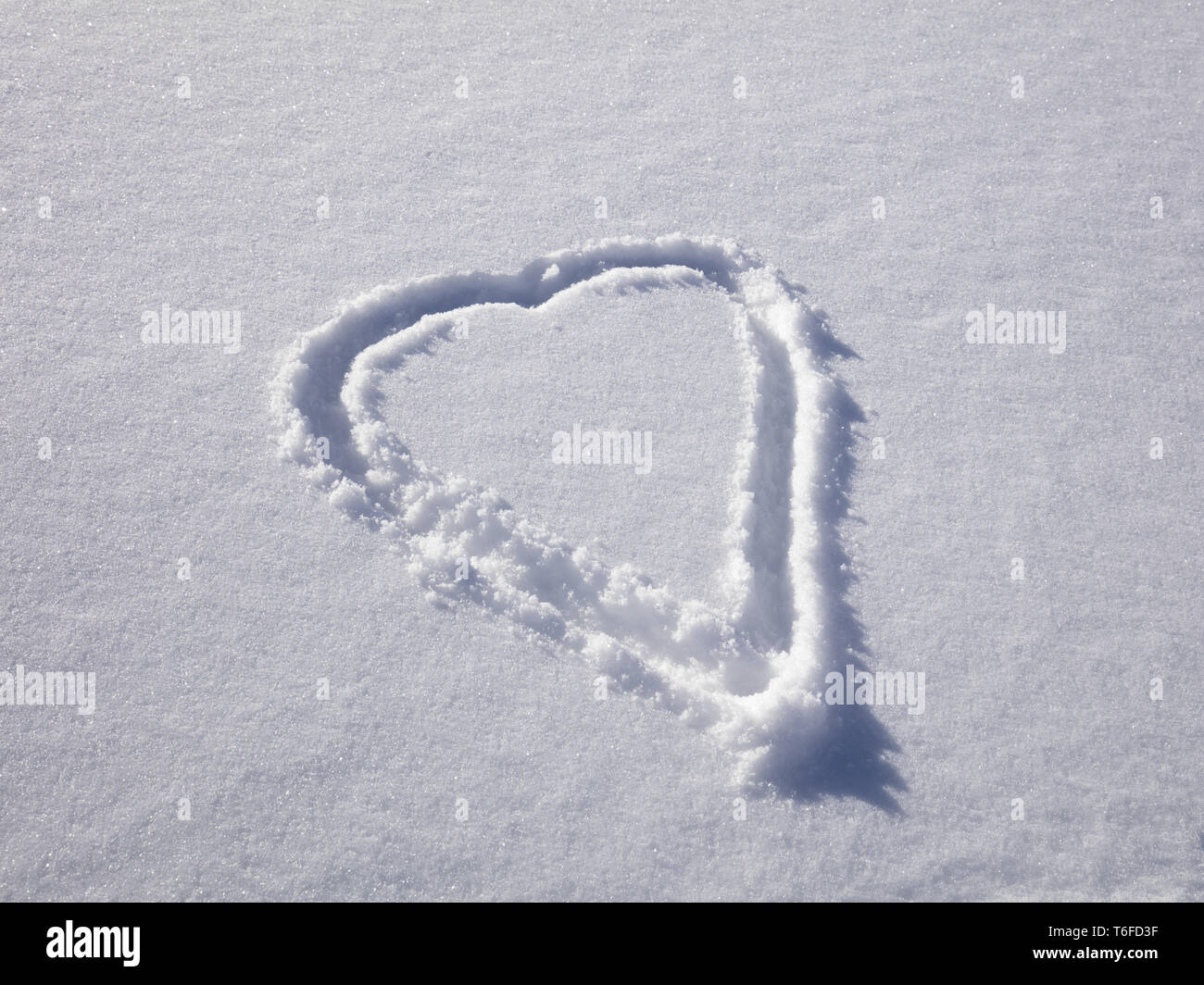 Heart in snow Stock Photo - Alamy
