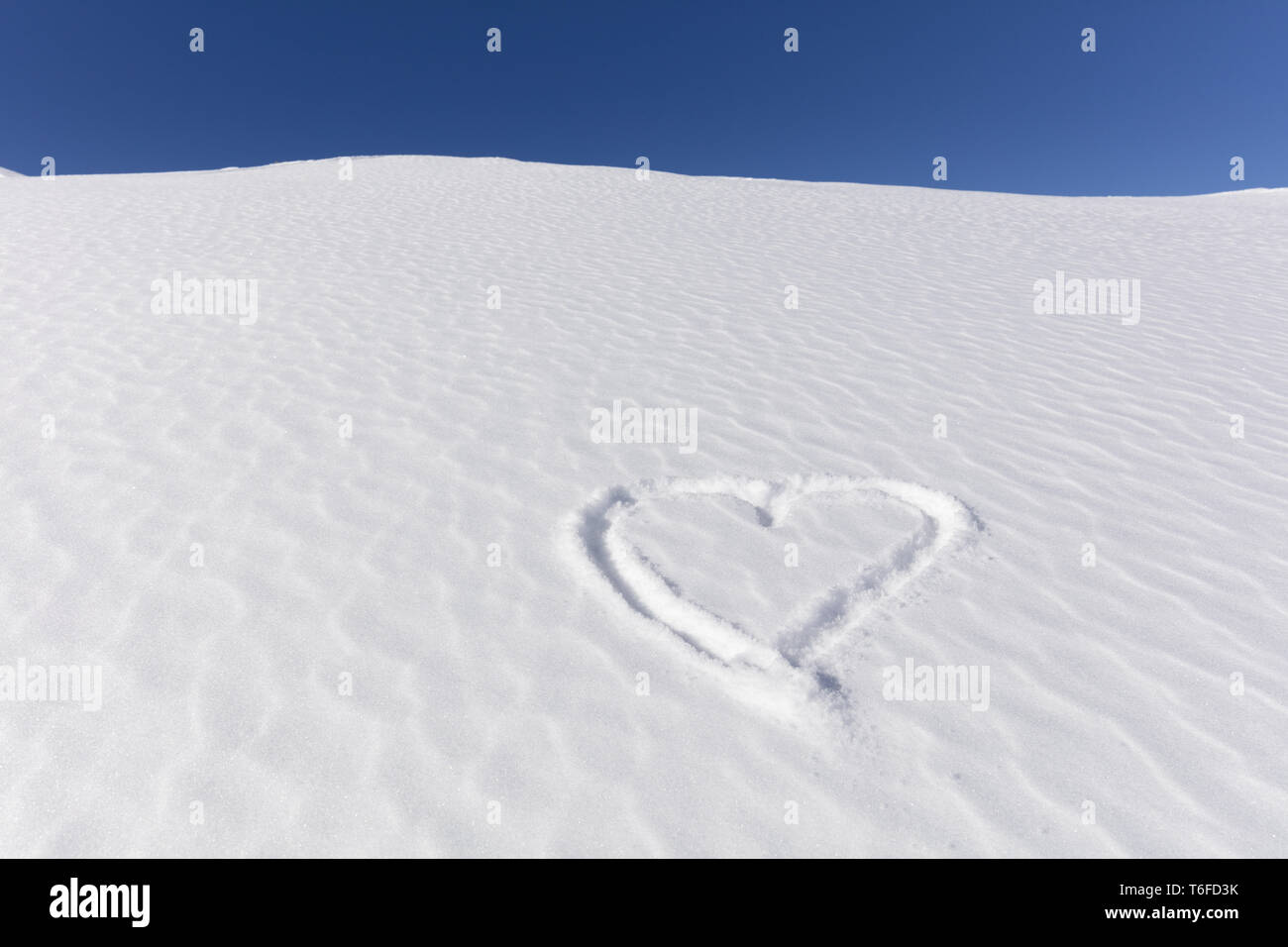Heart in snow Stock Photo - Alamy