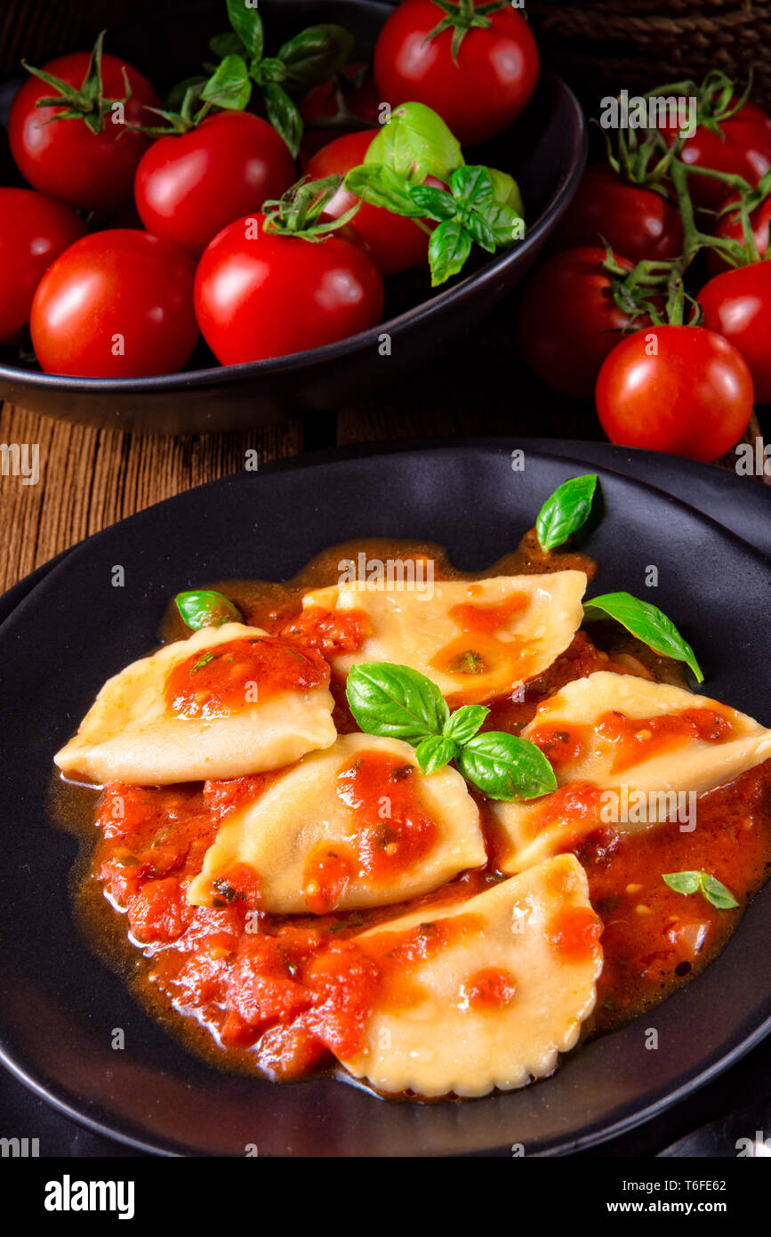 rustic Delicious Pasta - Ravioli in tomato sauce with basil Stock Photo ...