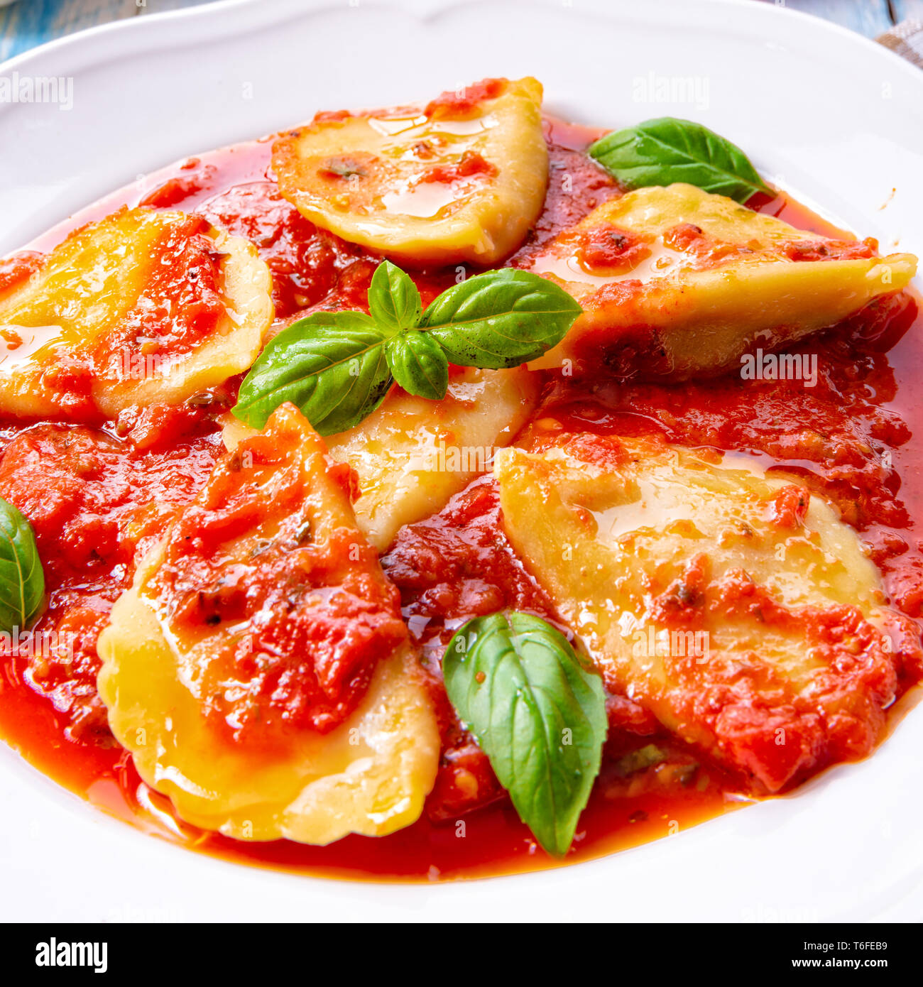Delicious pasta - ravioli in tomato sauce with basil Stock Photo - Alamy