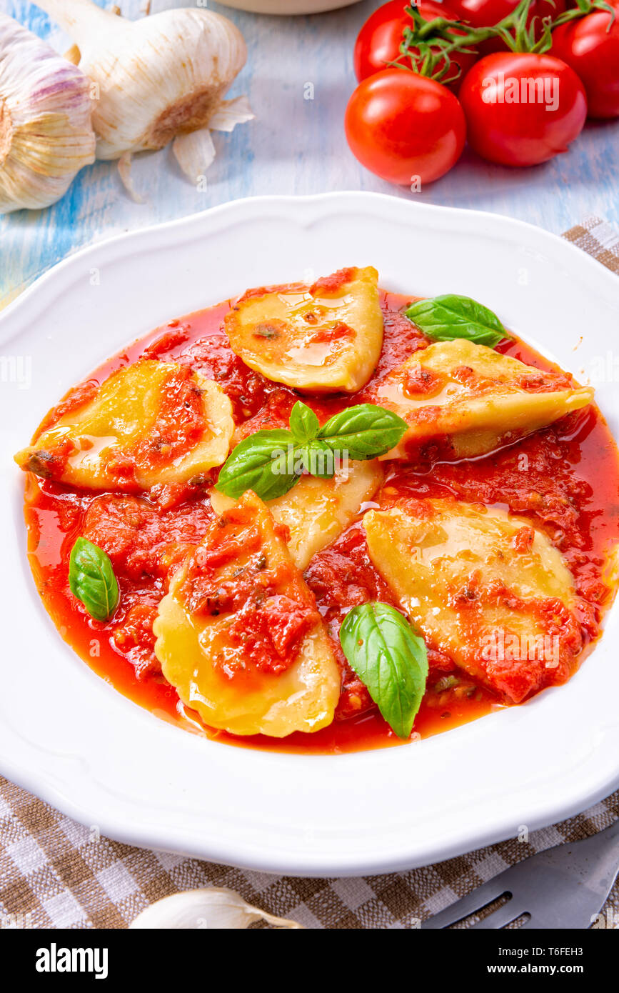 Delicious pasta - ravioli in tomato sauce with basil Stock Photo - Alamy