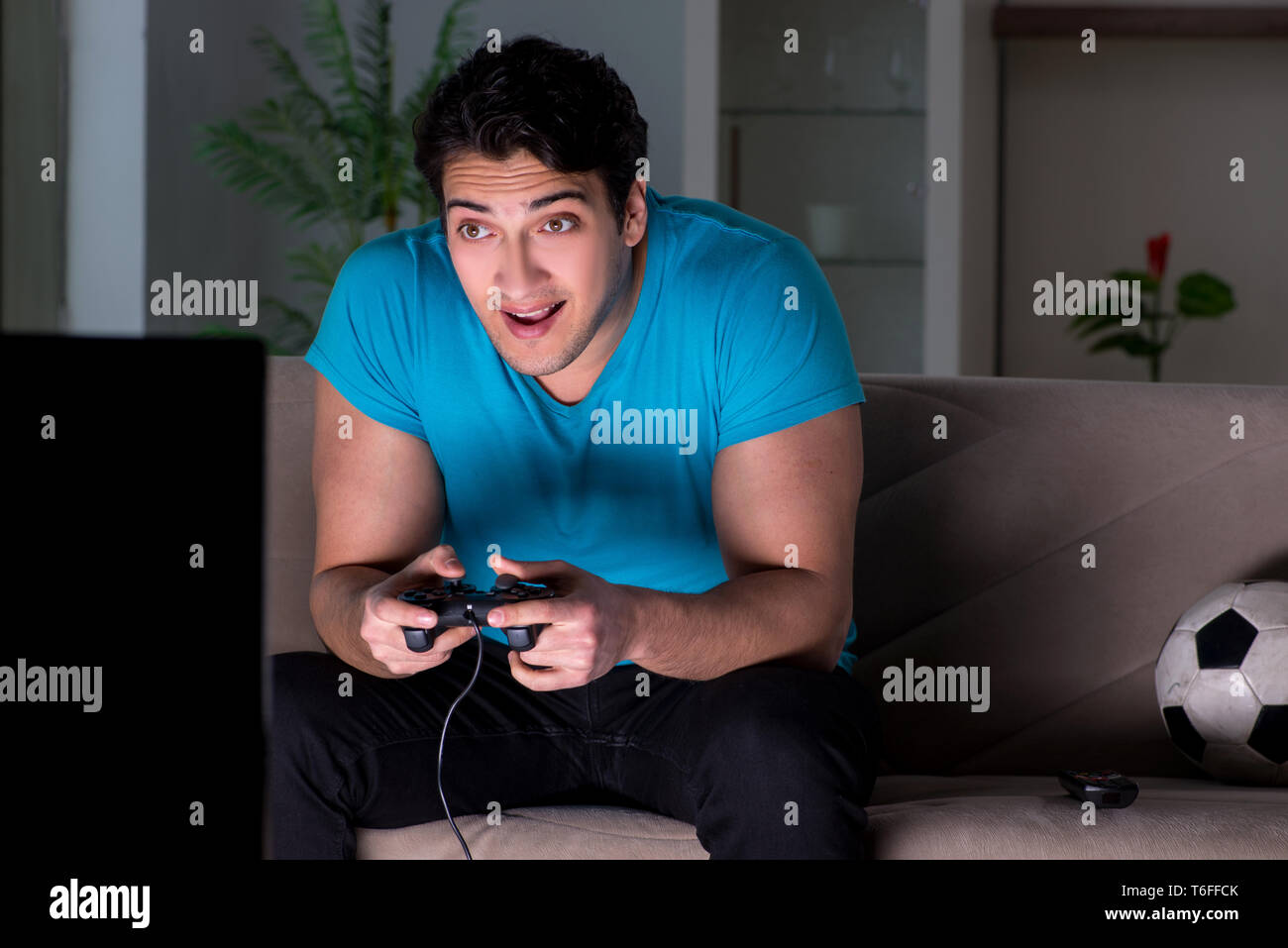 Young man playing computer games late at night Stock Photo - Alamy
