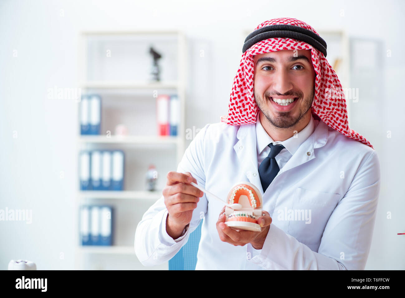 Arab dentist working on new teeth implant Stock Photo - Alamy