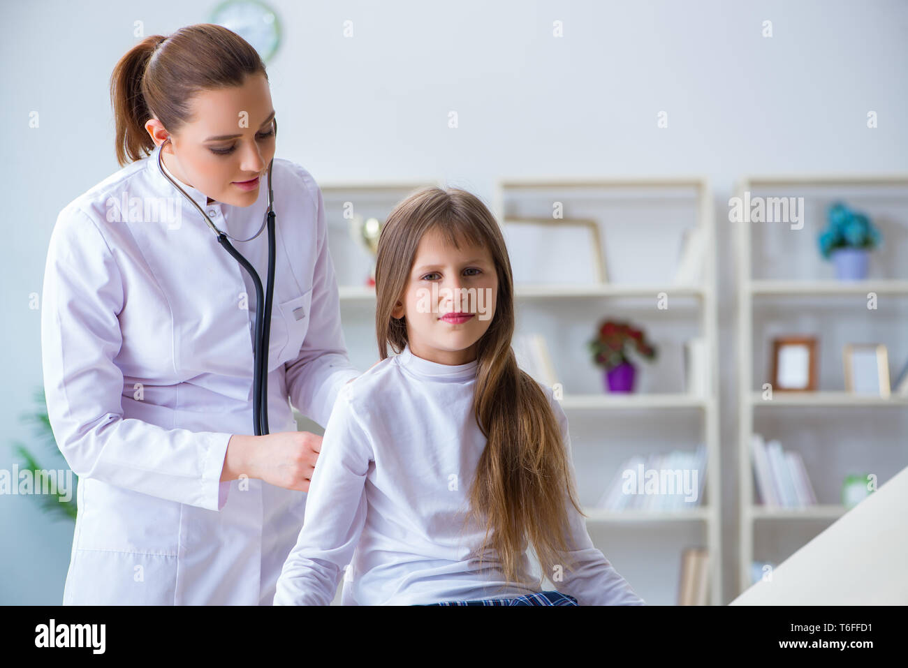 Female doctor pediatrician checking girl Stock Photo - Alamy