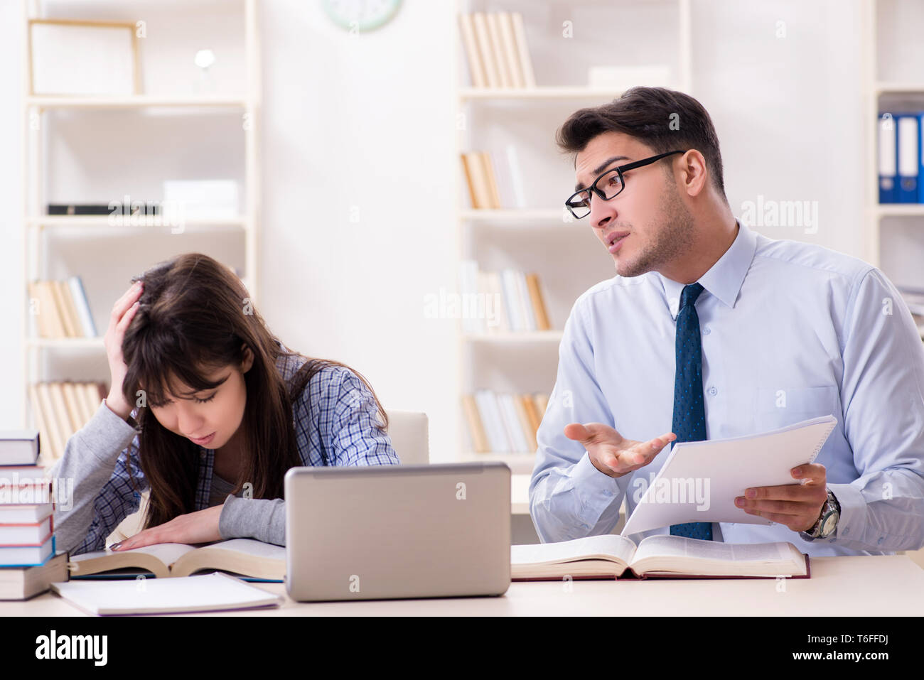 Male lecturer giving lecture to female student Stock Photo - Alamy