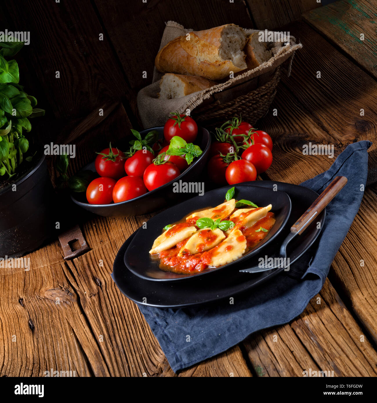 rustic Delicious Pasta - Ravioli in tomato sauce with basil Stock Photo ...