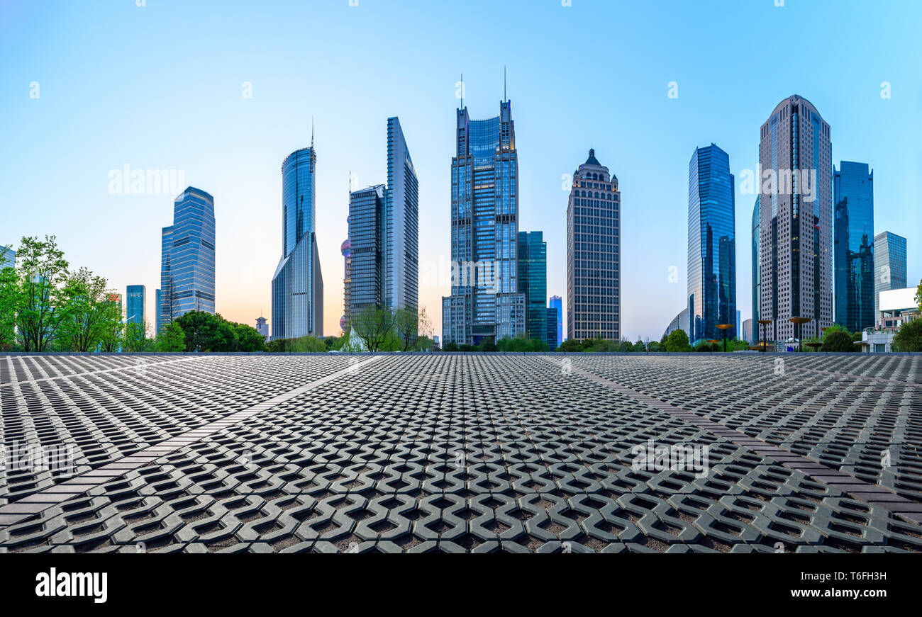 Shanghai modern commercial office buildings and square floor at dusk ...