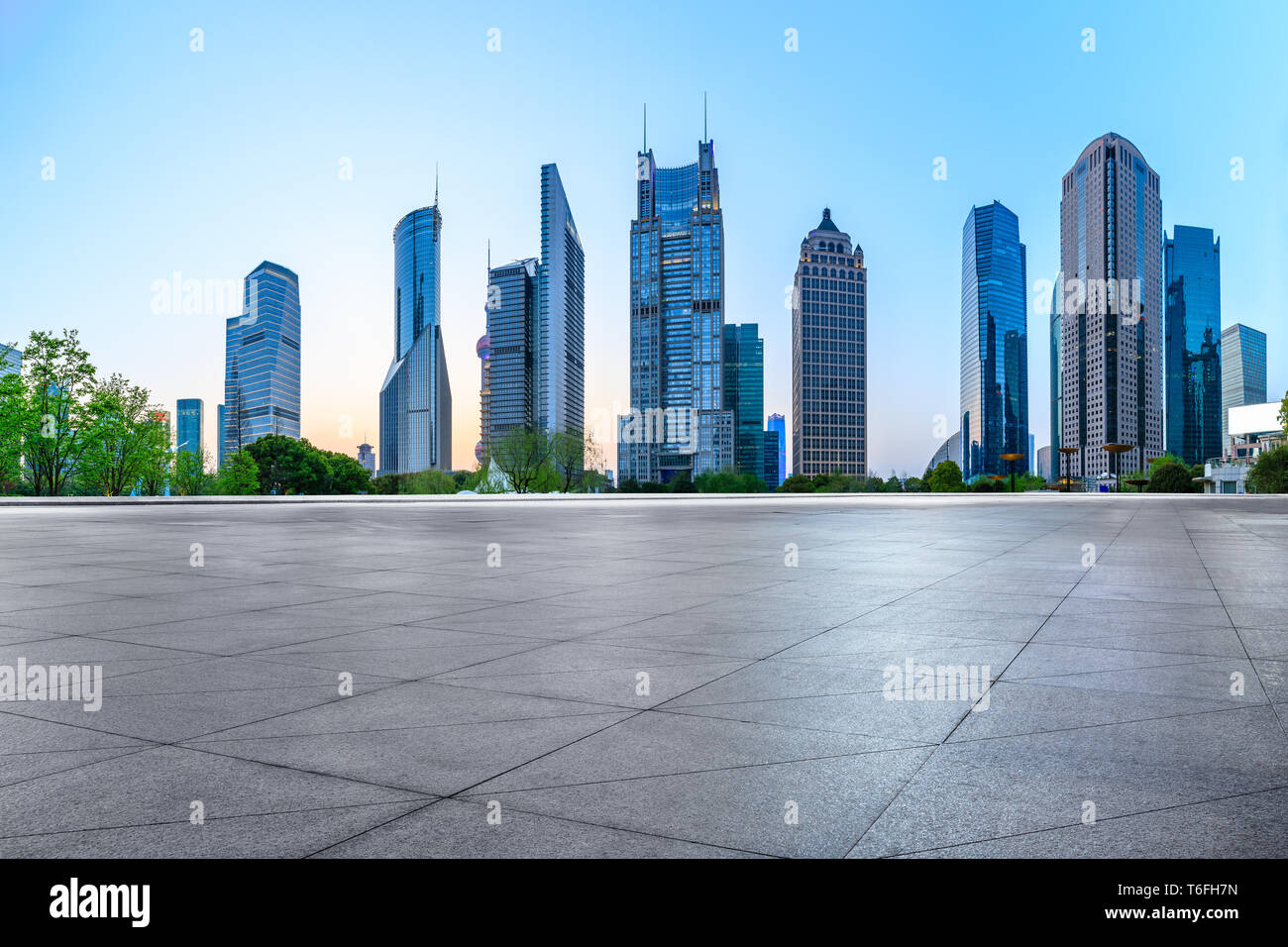 Shanghai modern commercial office buildings and square floor at dusk ...