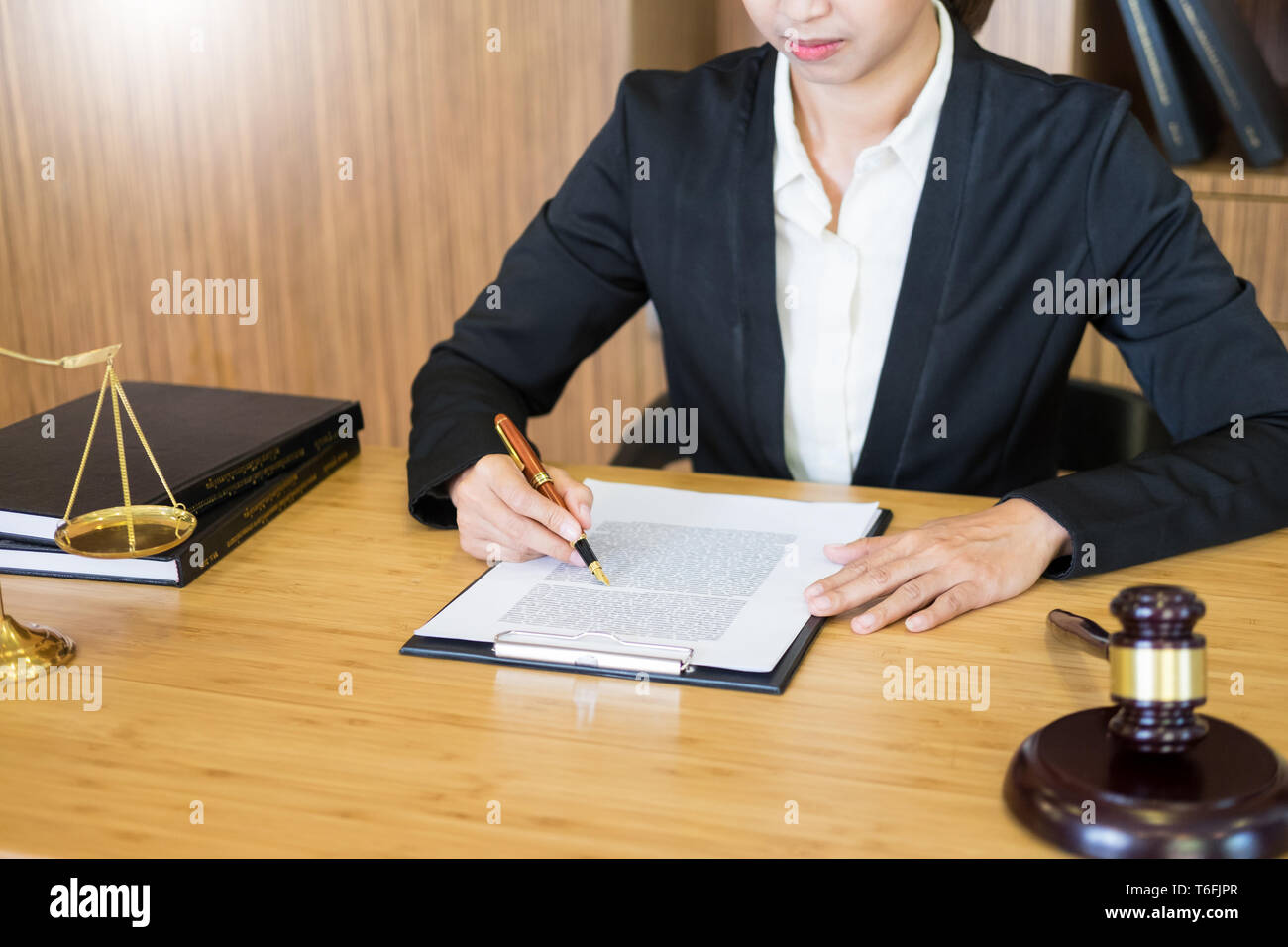 lawyer judge reading documents at desk in courtroom working on wooden ...
