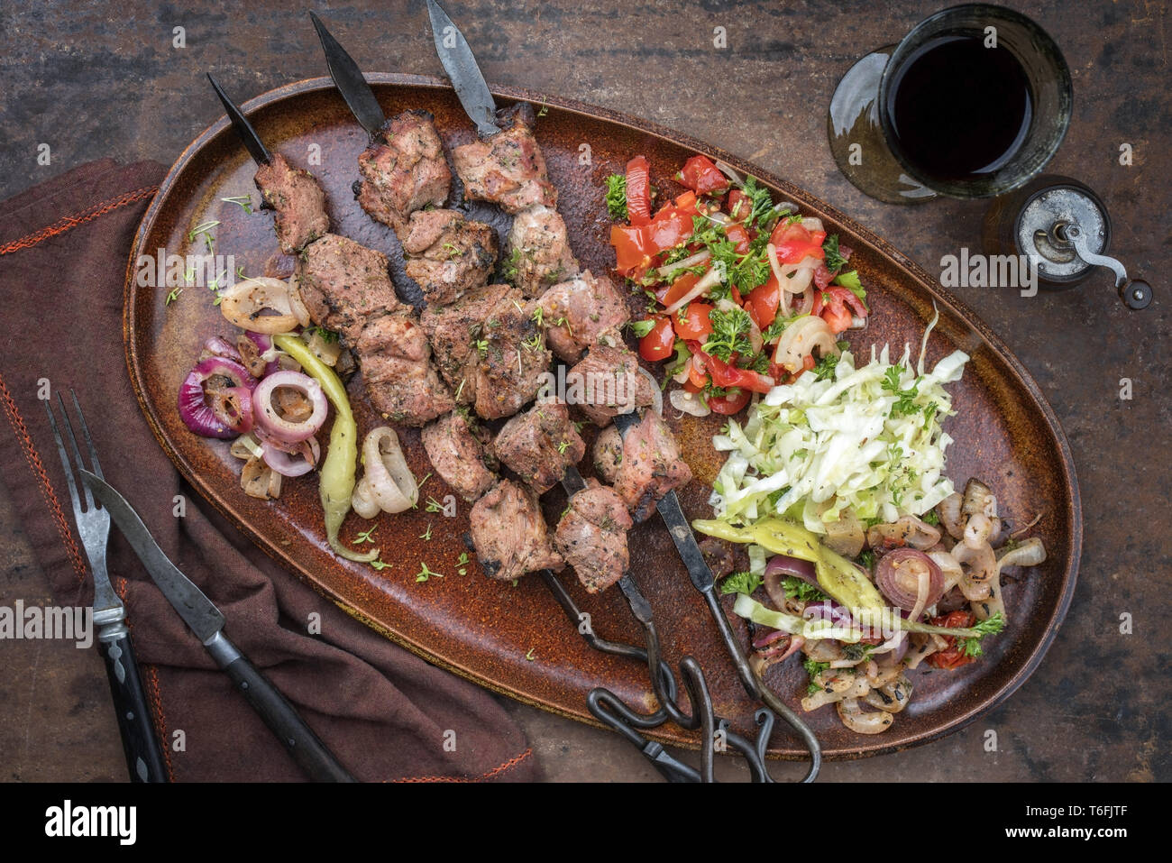 Traditional Turkish lamb kebab barbecue skewer with cabbage and tomato ...