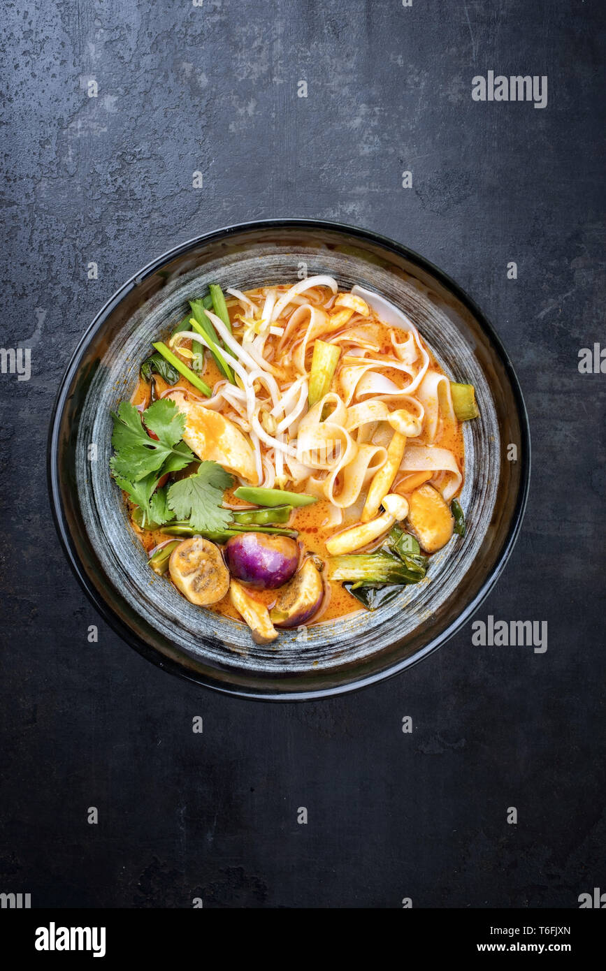 Traditional Thai kaeng phet red curry with vegetables and rice noodles ...