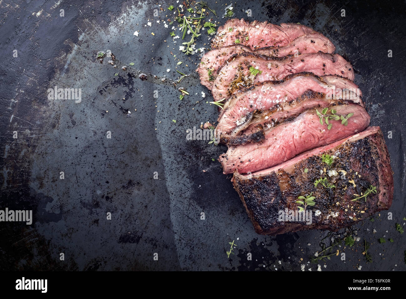 Barbecue wagyu roast beef sliced as top view on a metal board with copy ...