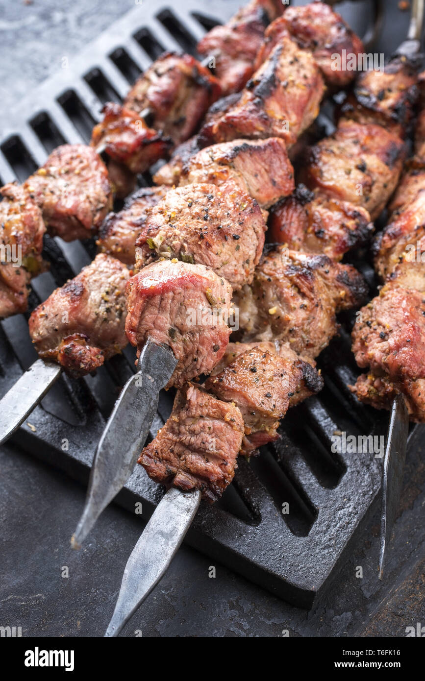 Traditional Russian shashlik on a barbecue skewer as top view on ...