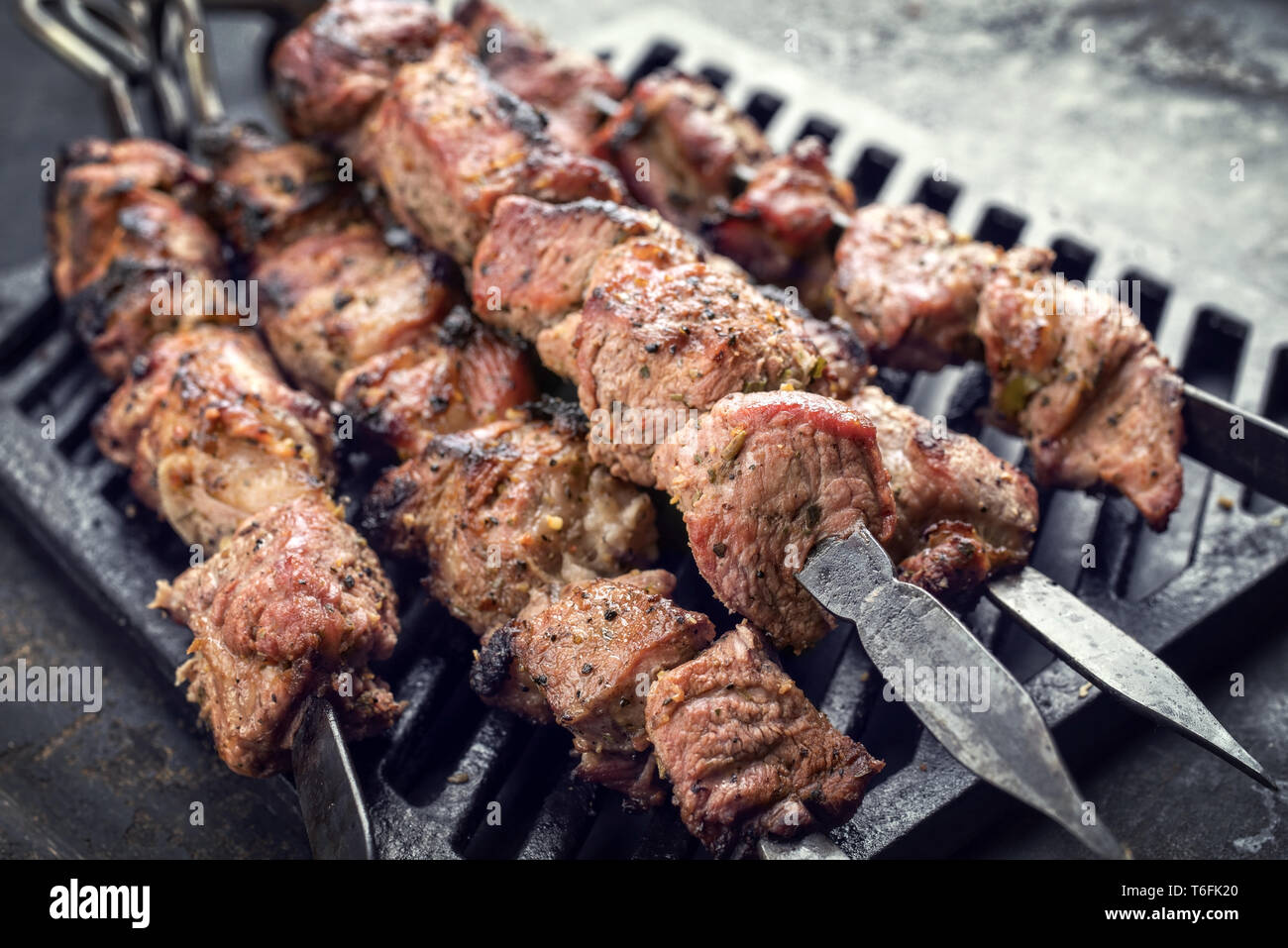 Traditional Russian shashlik on a barbecue skewer as top view on ...
