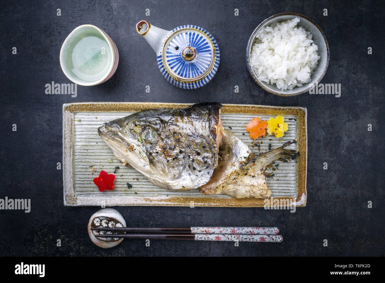 Traditional barbecue Japanese Kama Yaki salmon fish head with rice as ...