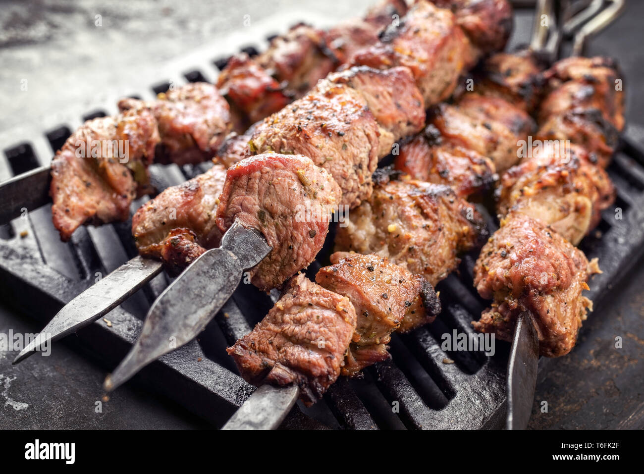 Traditional Russian shashlik on a barbecue skewer as top view on ...