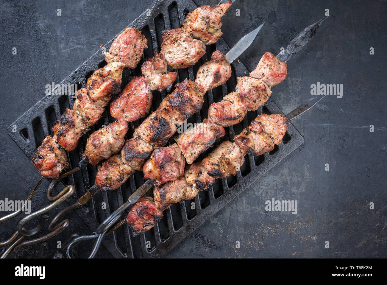 Traditional Russian shashlik on a barbecue skewer as top view on ...