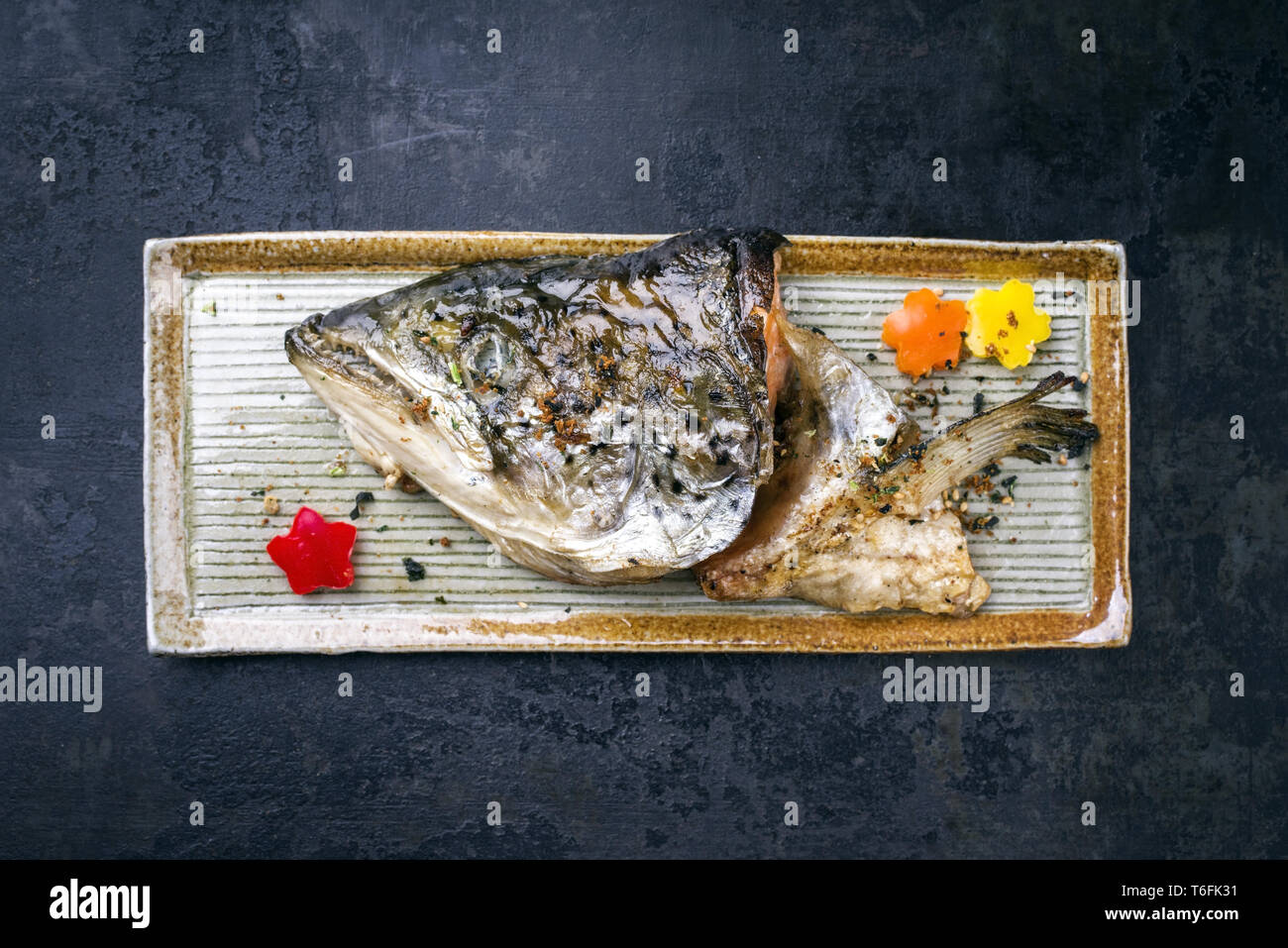 Traditional Japanese barbecue Kama Yaki salmon fish head as close-up on ...