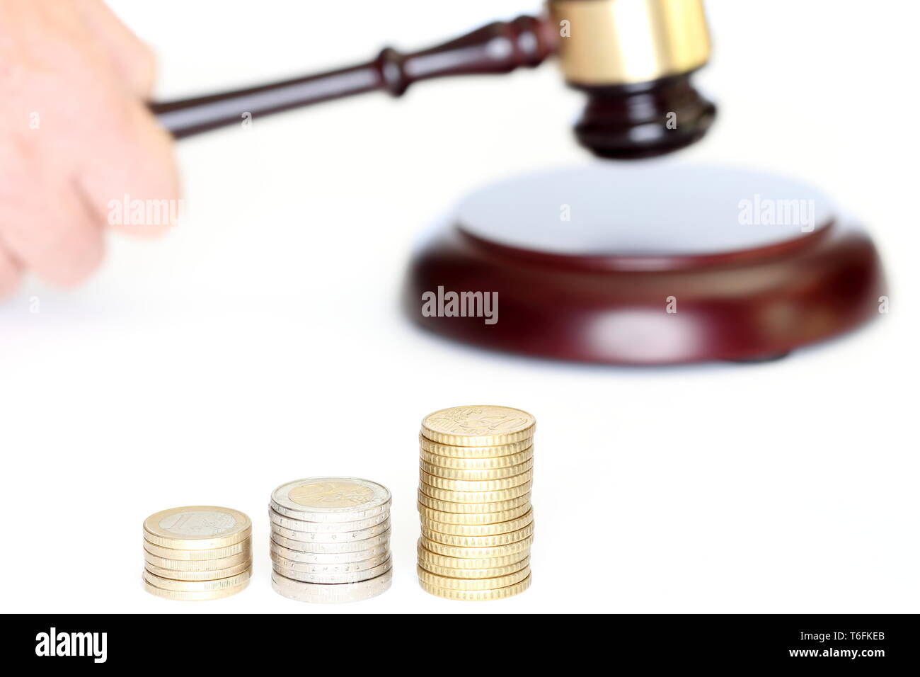 money coins and hammer on white background Stock Photo - Alamy