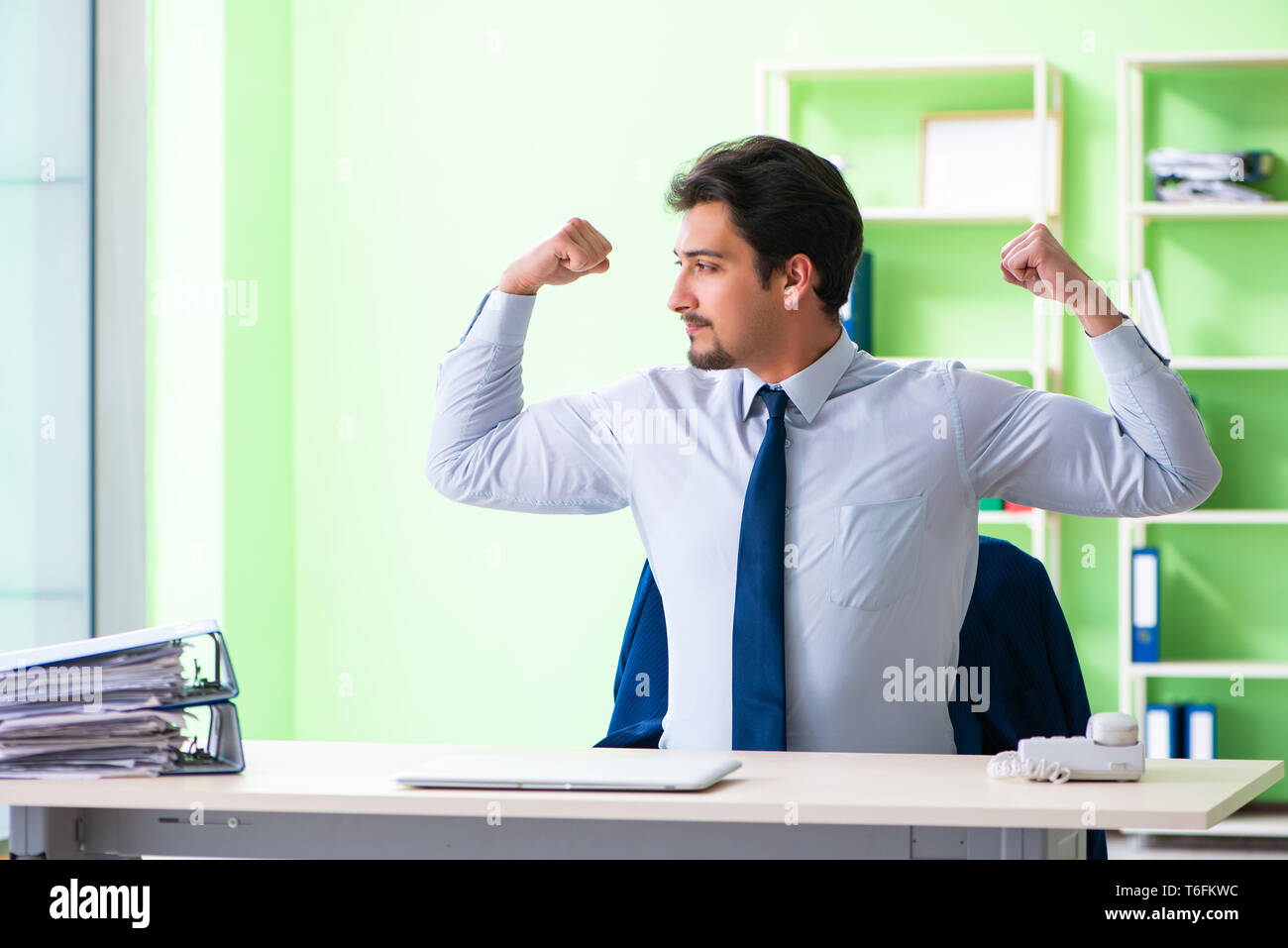Employee doing exercises during break at work Stock Photo - Alamy