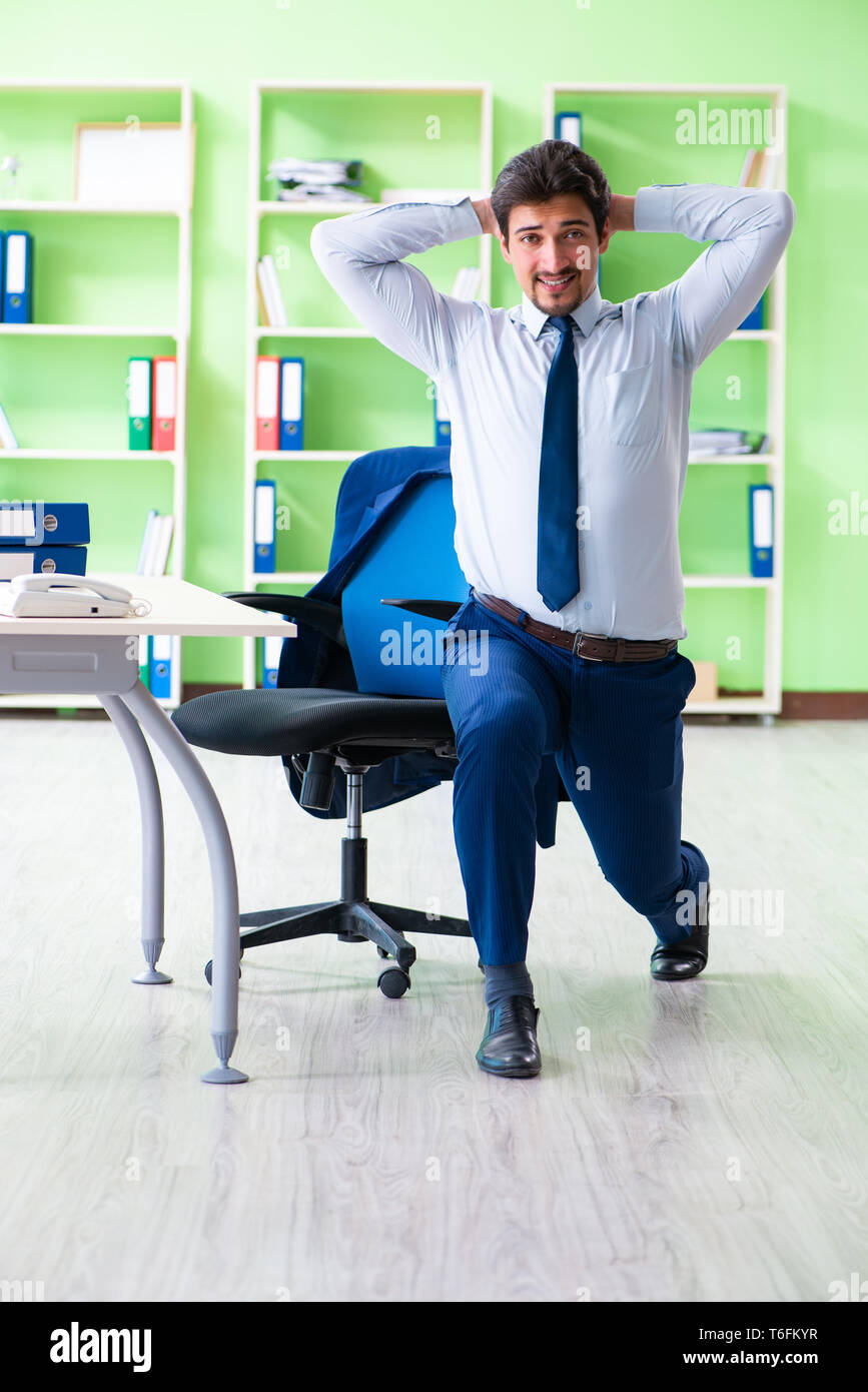 Employee doing exercises during break at work Stock Photo - Alamy