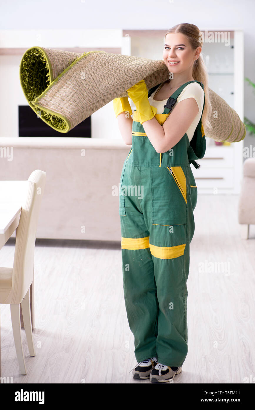 Professional female cleaner cleaning carpet Stock Photo - Alamy
