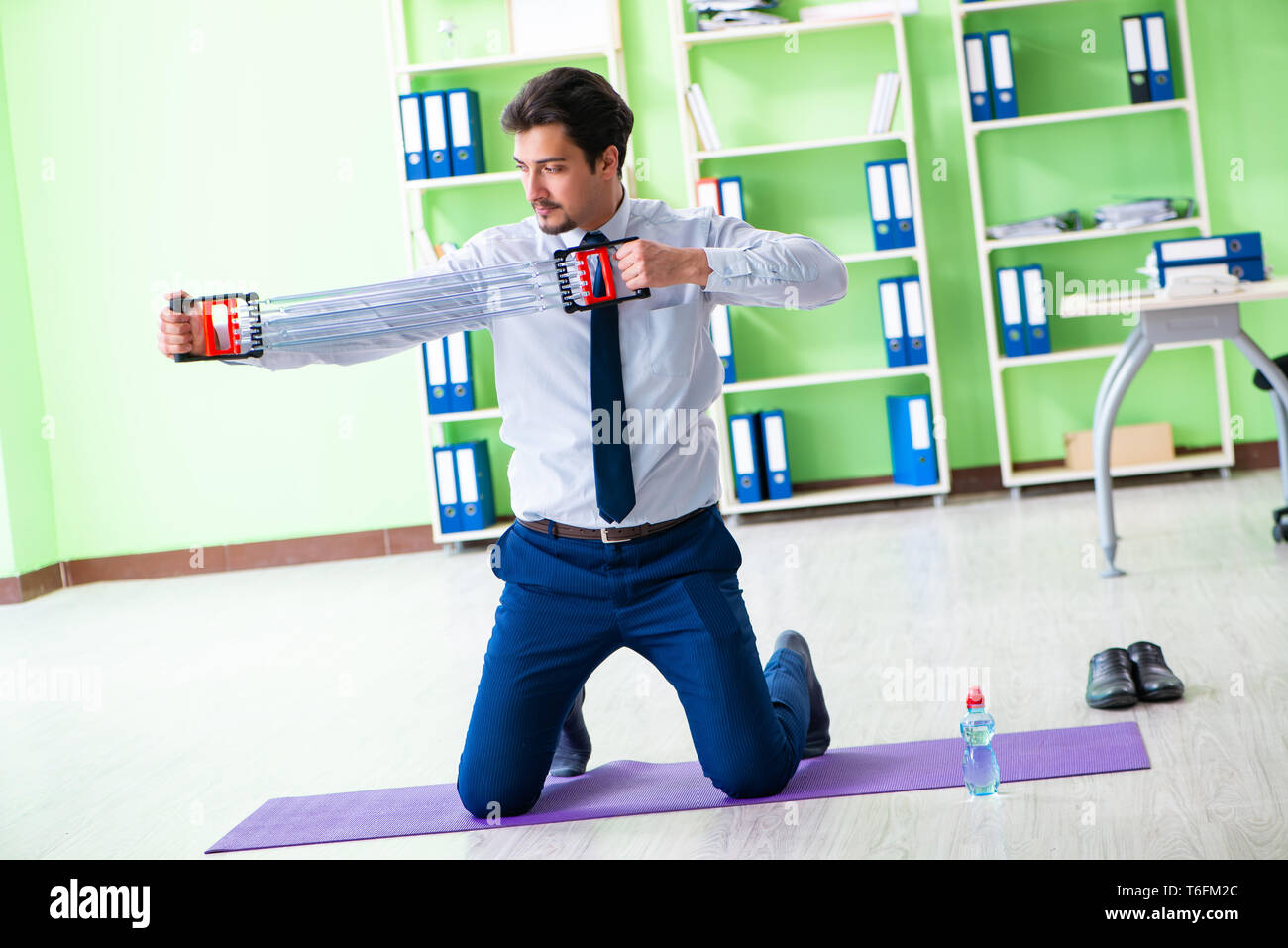 Employee doing exercises during break at work Stock Photo - Alamy