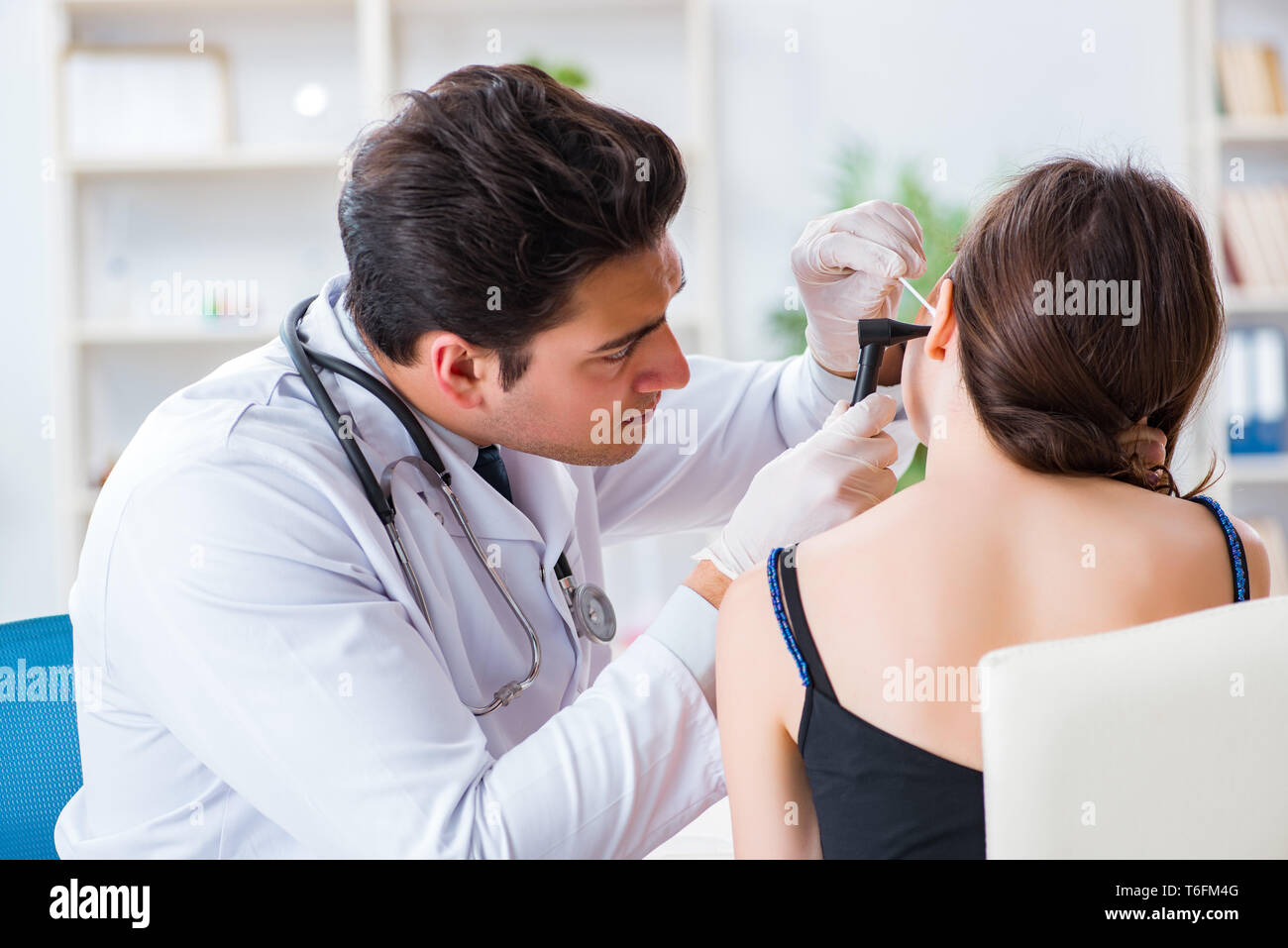Doctor checking patients ear during medical examination Stock Photo - Alamy