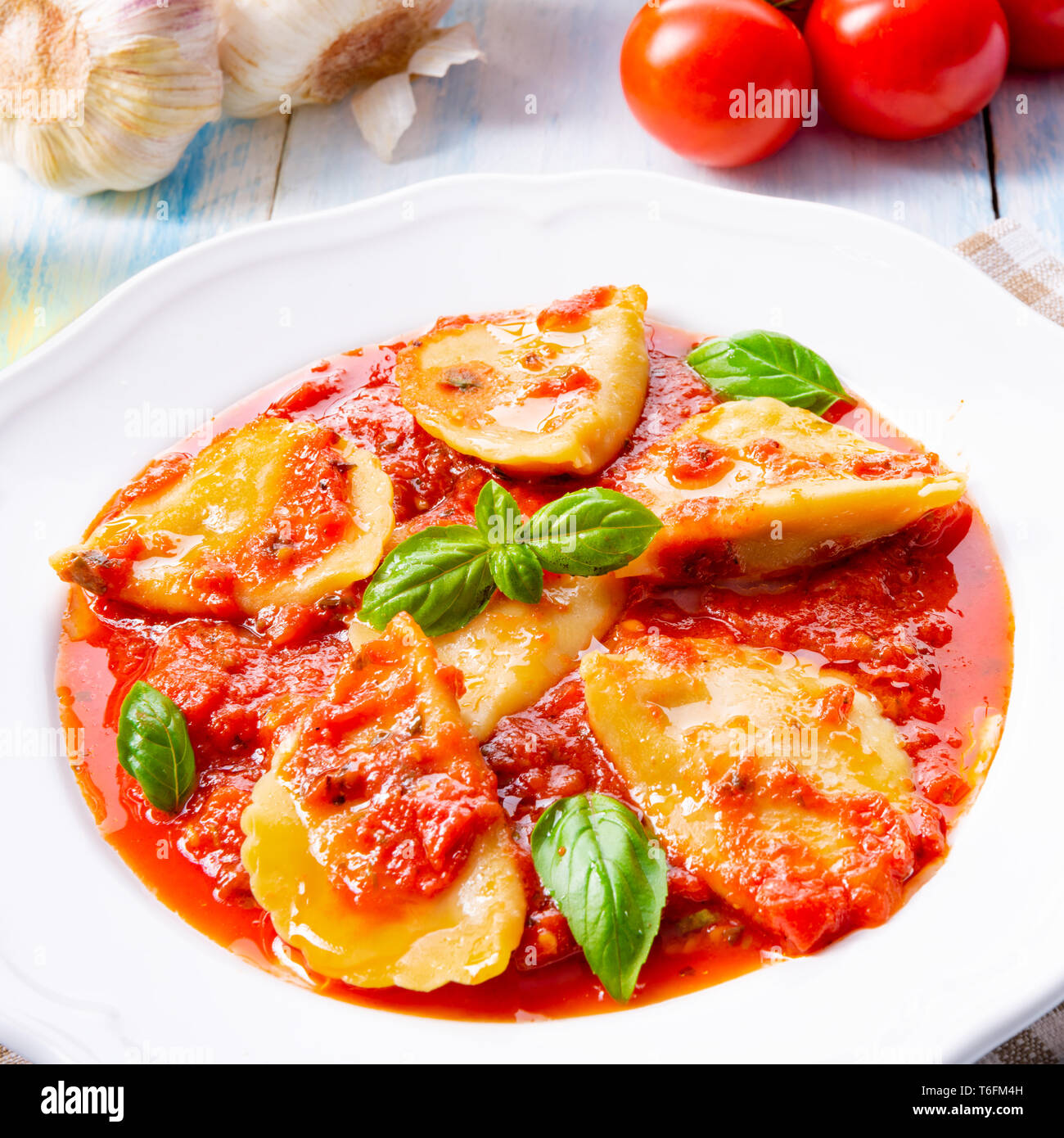 Delicious pasta - ravioli in tomato sauce with basil Stock Photo - Alamy