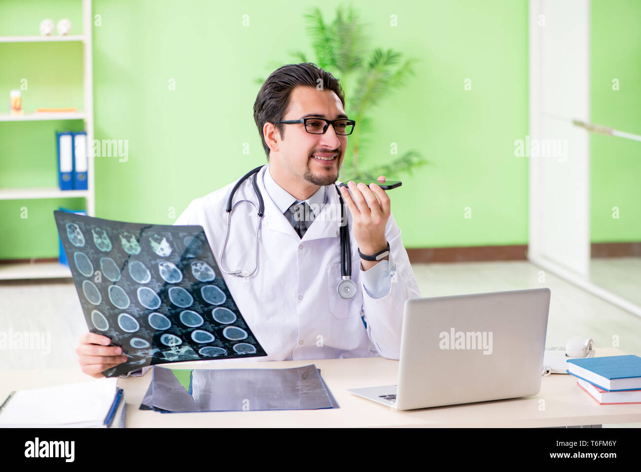 Doctor radiologist looking at x-ray scan in hospital Stock Photo - Alamy