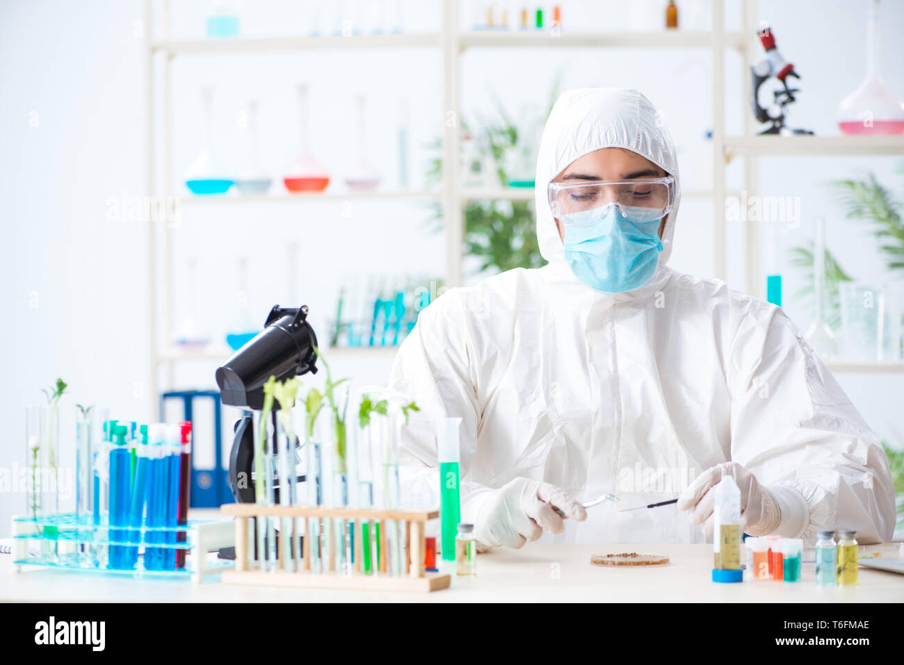 Biochemist working on microscope hi-res stock photography and images ...