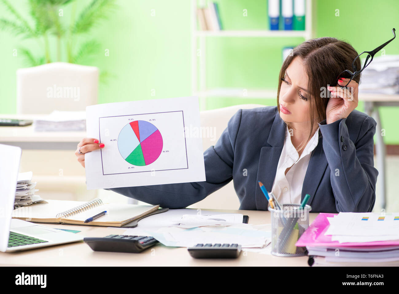 Female financial manager presenting graph chart sitting in the o Stock ...