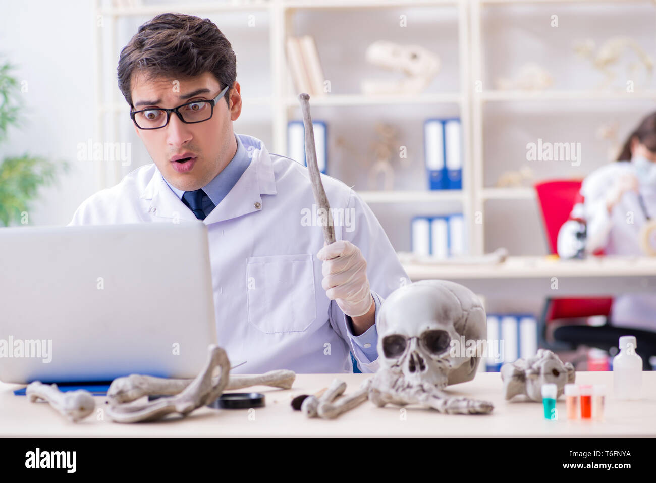 Professor studying human skeleton in lab Stock Photo - Alamy