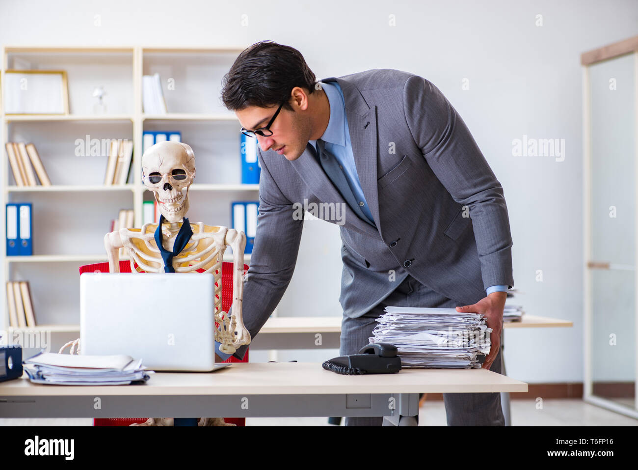 Angry boss yelling at his skeleton employee Stock Photo - Alamy