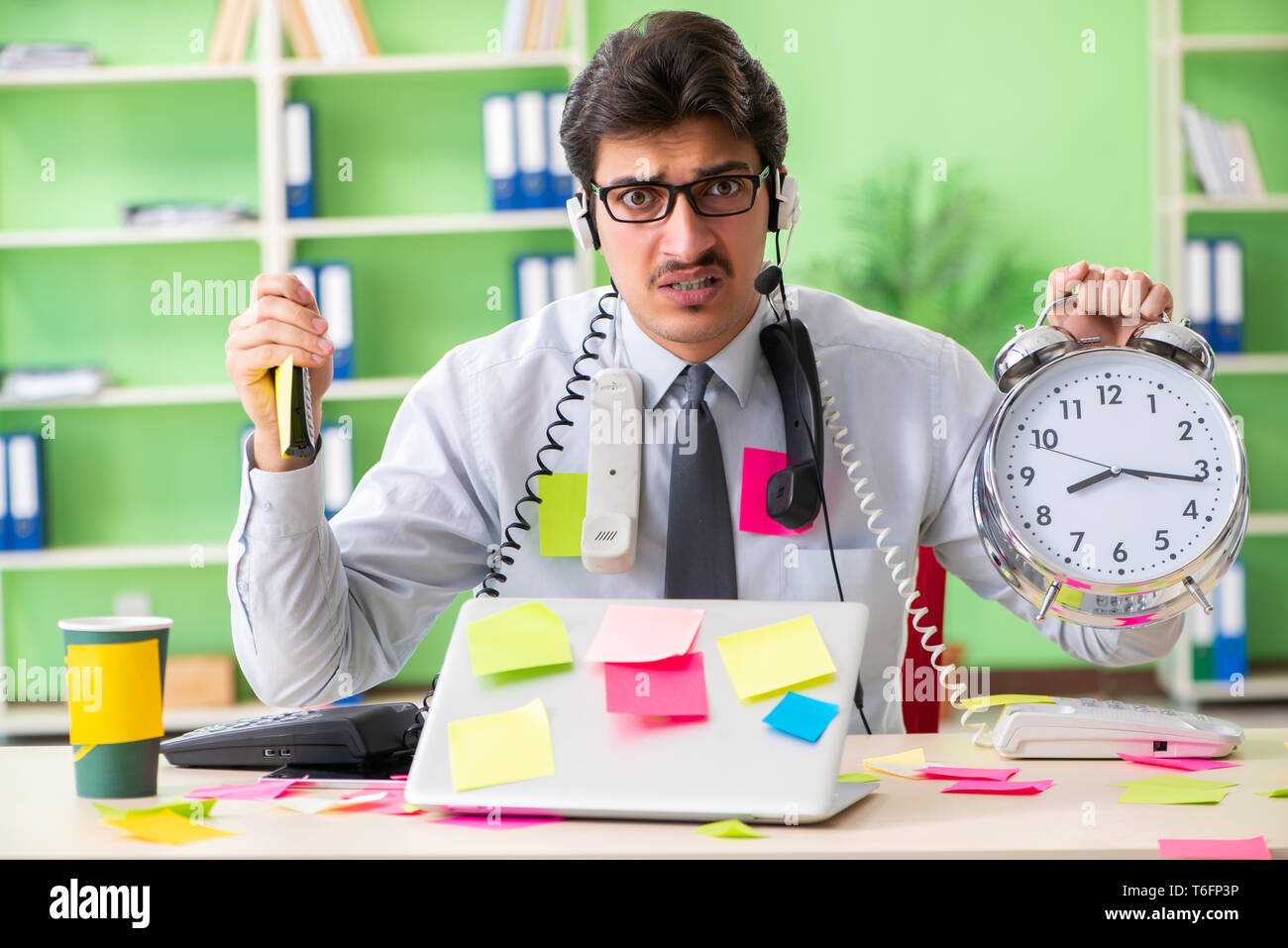 Young help desk operator working in office with many conflicting Stock ...