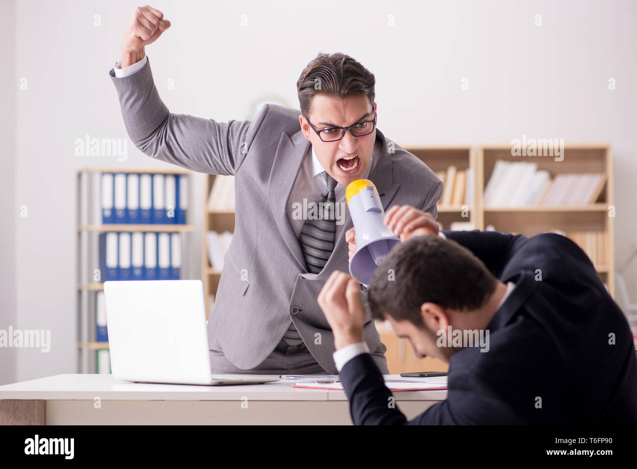 Angry boss shouting at his employee Stock Photo - Alamy