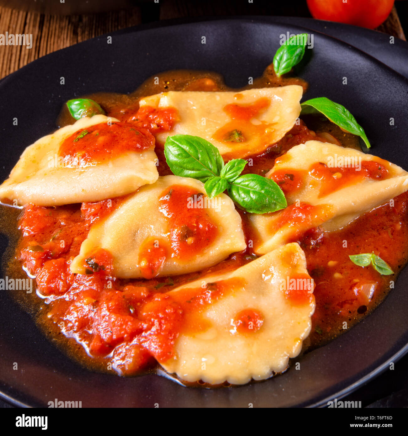 rustic Delicious Pasta - Ravioli in tomato sauce with basil Stock Photo ...