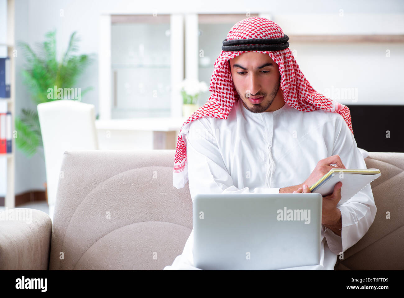 Arab man working at home on his work Stock Photo - Alamy