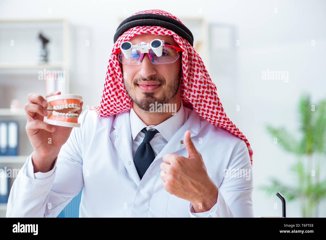 Arab dentist working on new teeth implant Stock Photo - Alamy