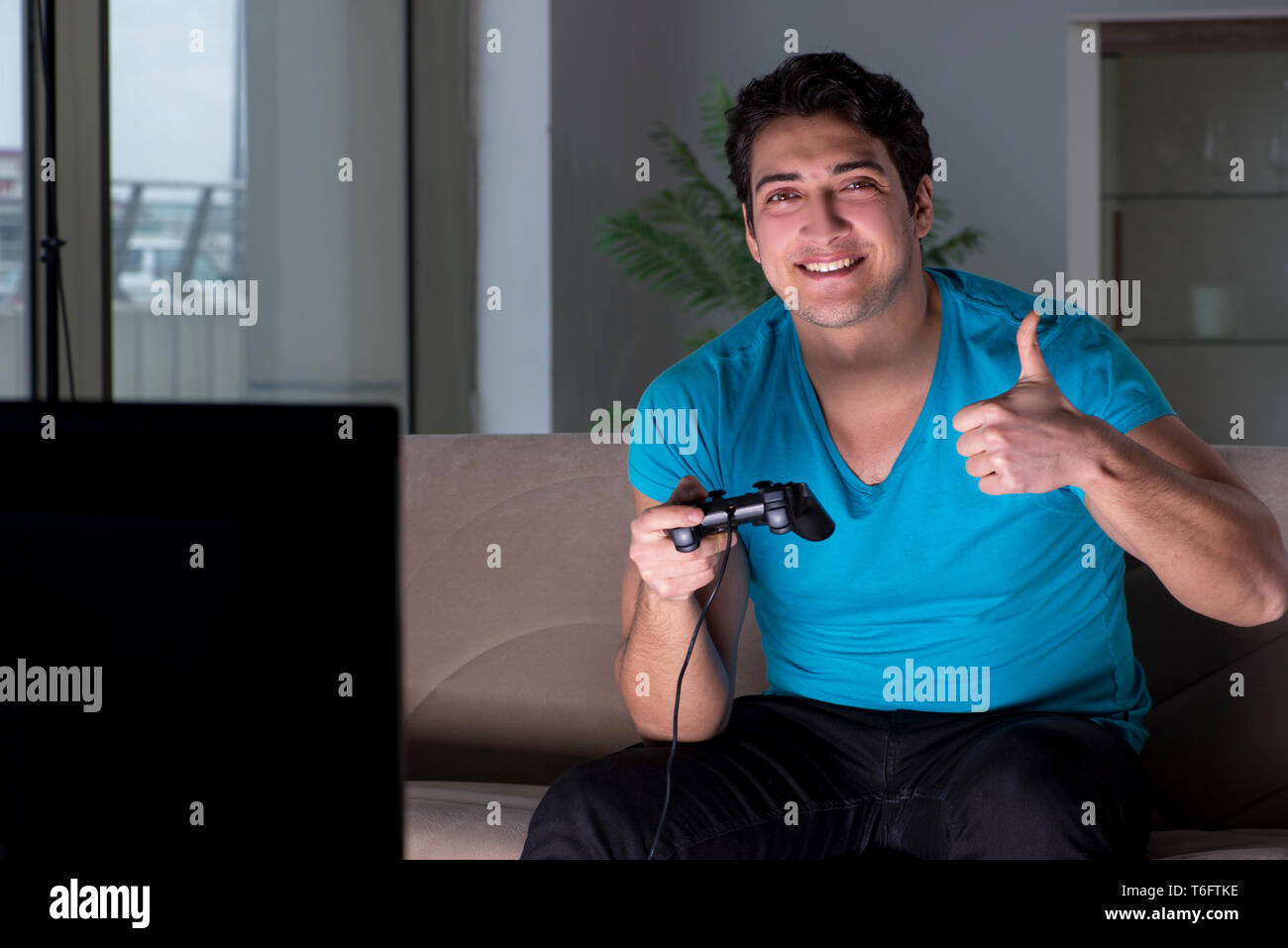 Young man playing computer games late at night Stock Photo - Alamy