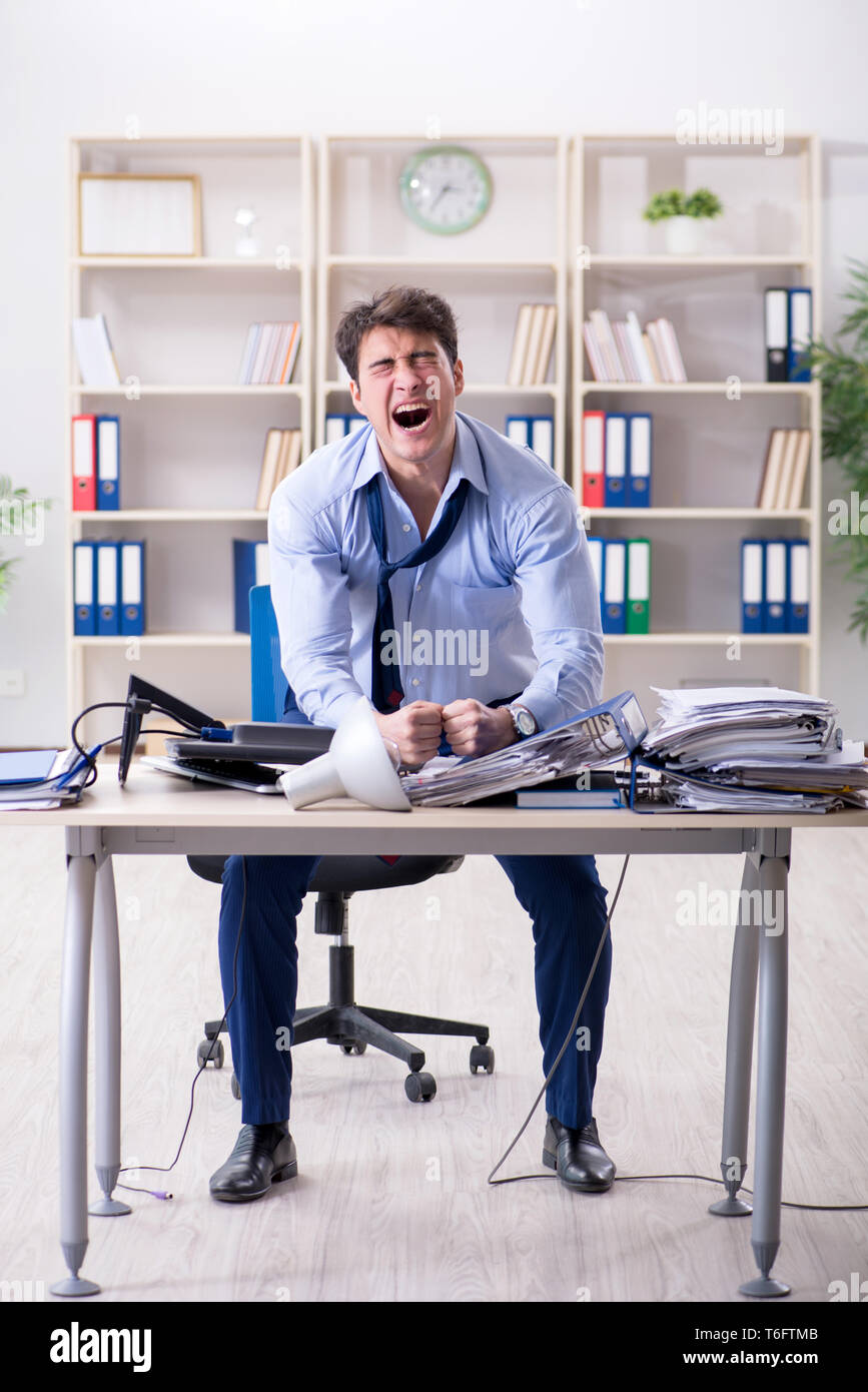Angry businessman frustrated with too much work Stock Photo - Alamy