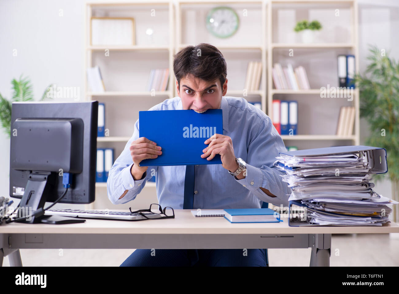 Tired businessman with too much paperwork Stock Photo - Alamy