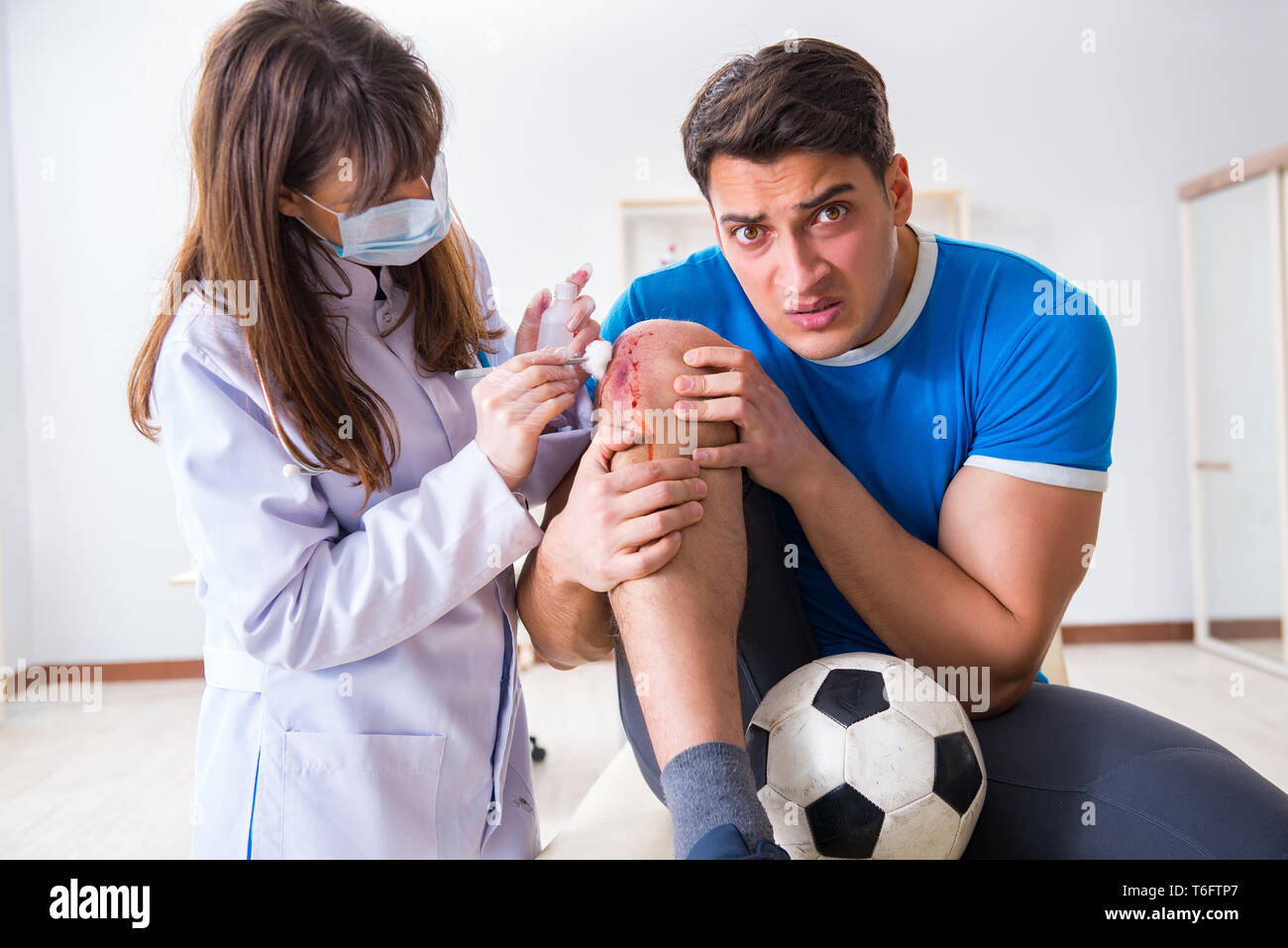 Football soccer player visiting doctor after injury Stock Photo - Alamy