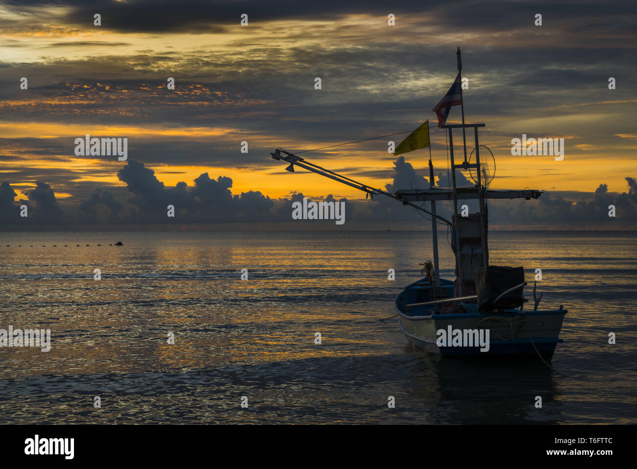 A fisherman boat in dawn Stock Photo - Alamy