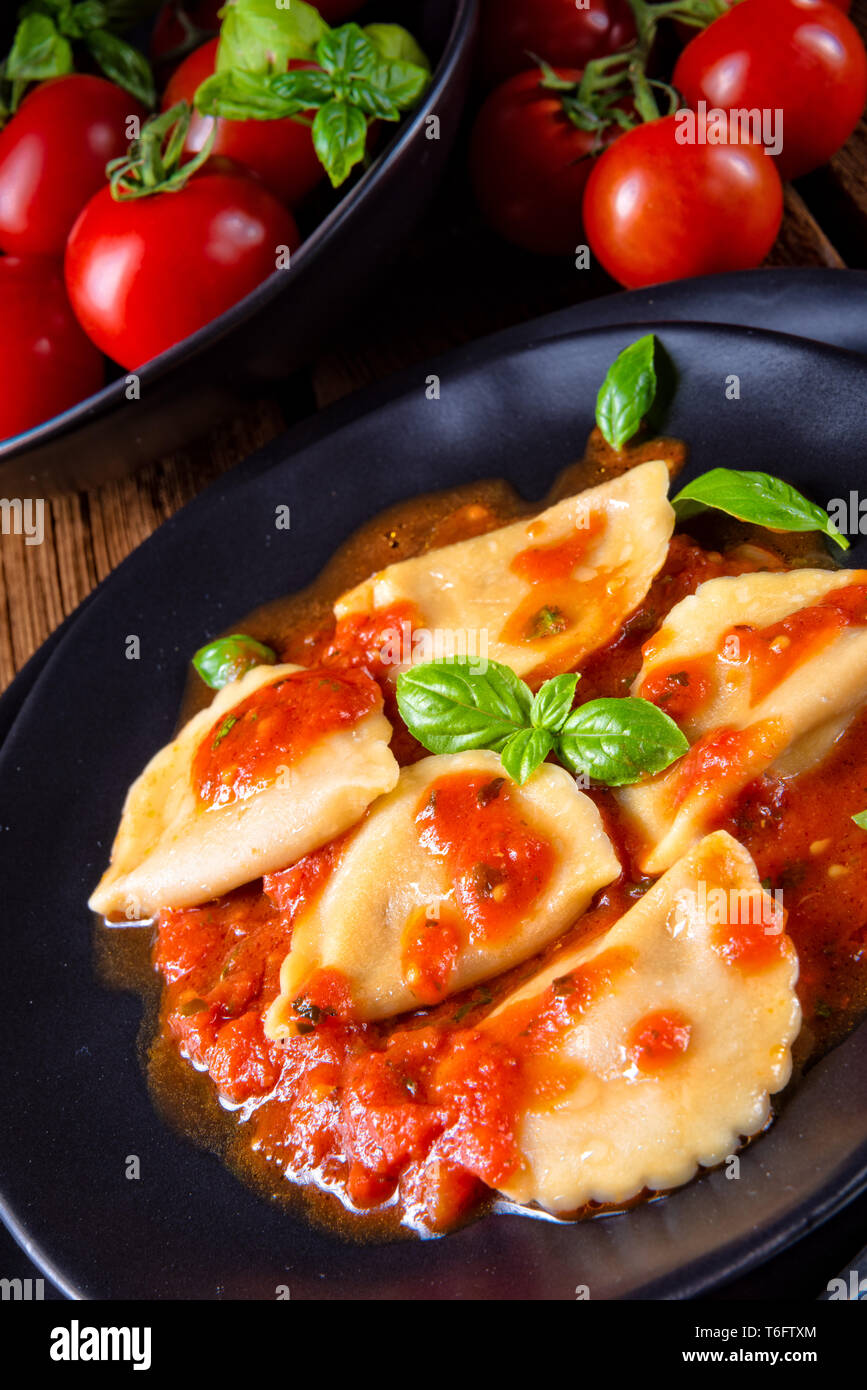rustic Delicious Pasta - Ravioli in tomato sauce with basil Stock Photo ...