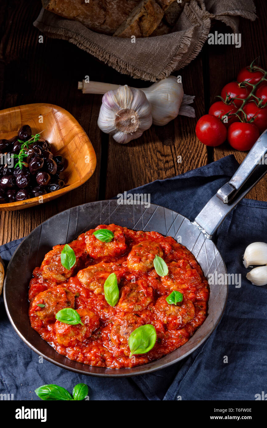 Rustic mini meatballs Baked in tomato sauce with basil Stock Photo - Alamy