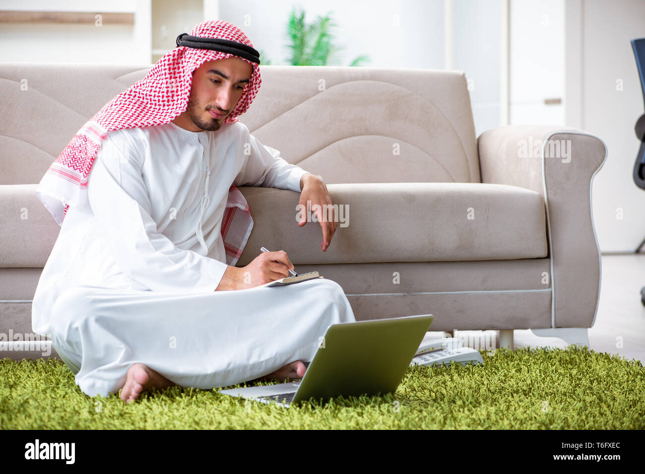 Arab man working at home on his work Stock Photo - Alamy