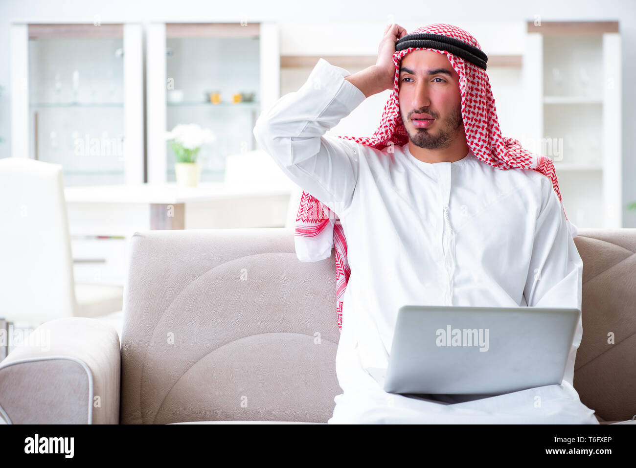 Arab man working at home on his work Stock Photo - Alamy